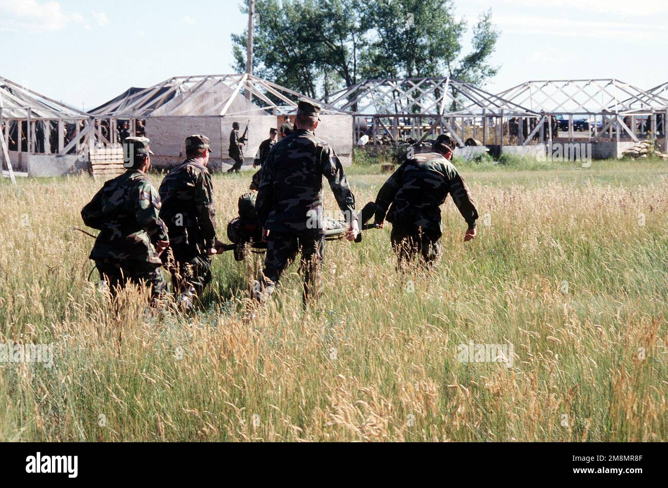 Members of the 341st Medical Group transport a "wounded" troop back to ...