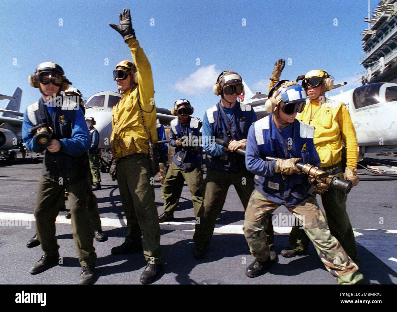 Crew members aboard the aircraft carrier USS NIMITZ (CVN 68) practice ...