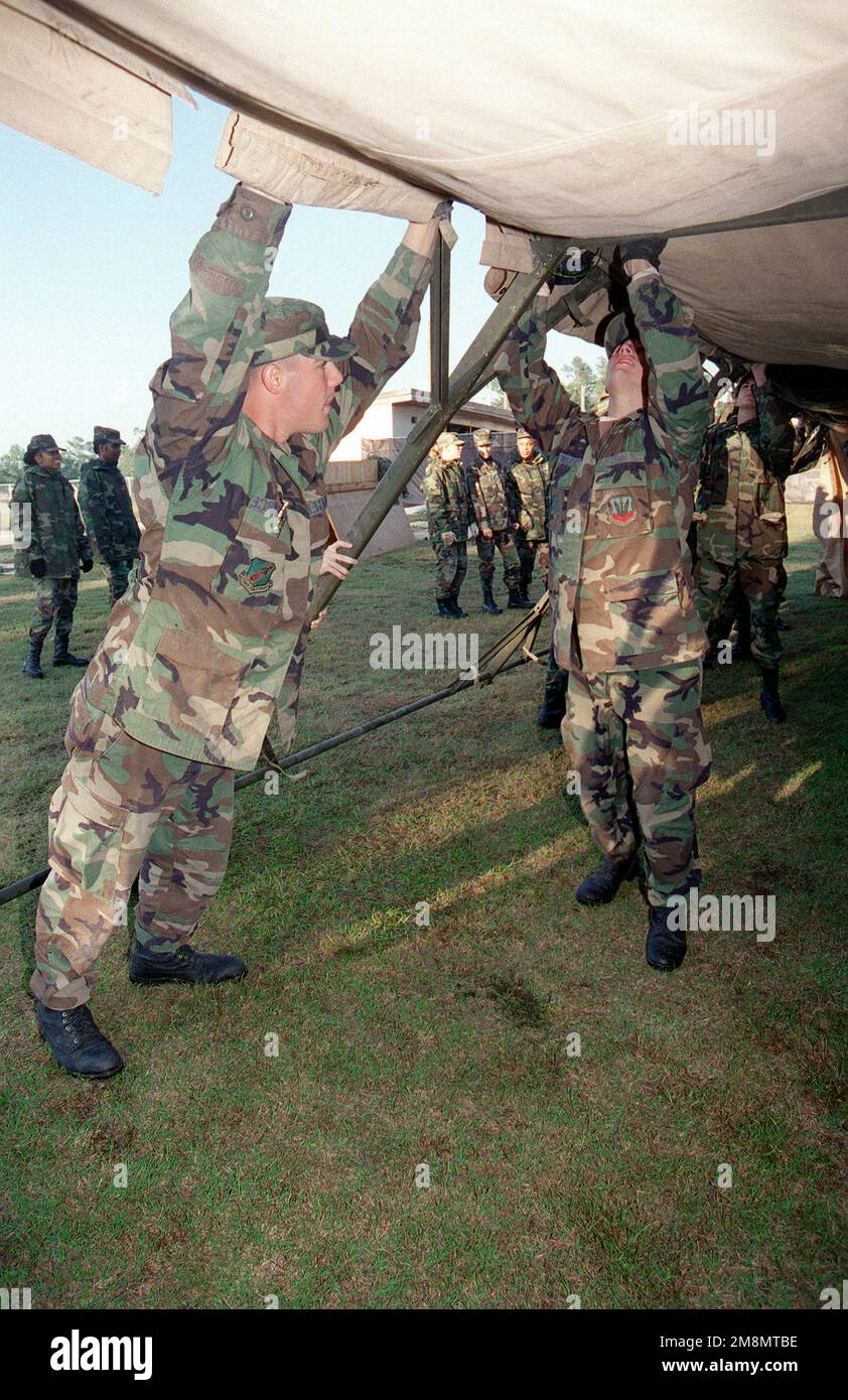 Members of the 4th Services Squadron put up their tents in preparation ...