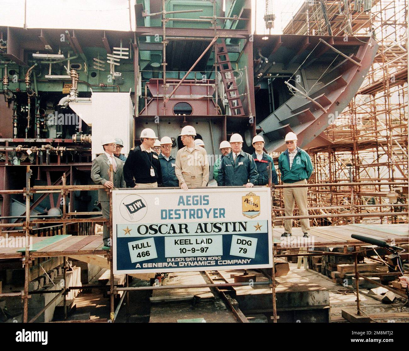 Unidentified shipyard officials and Navy officers pose for a photograph ...