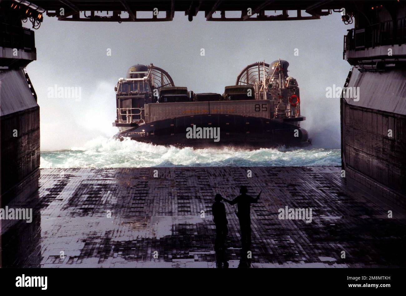 An Air-cushioned Landing Craft (LCAC) prepares to enter the well deck ...