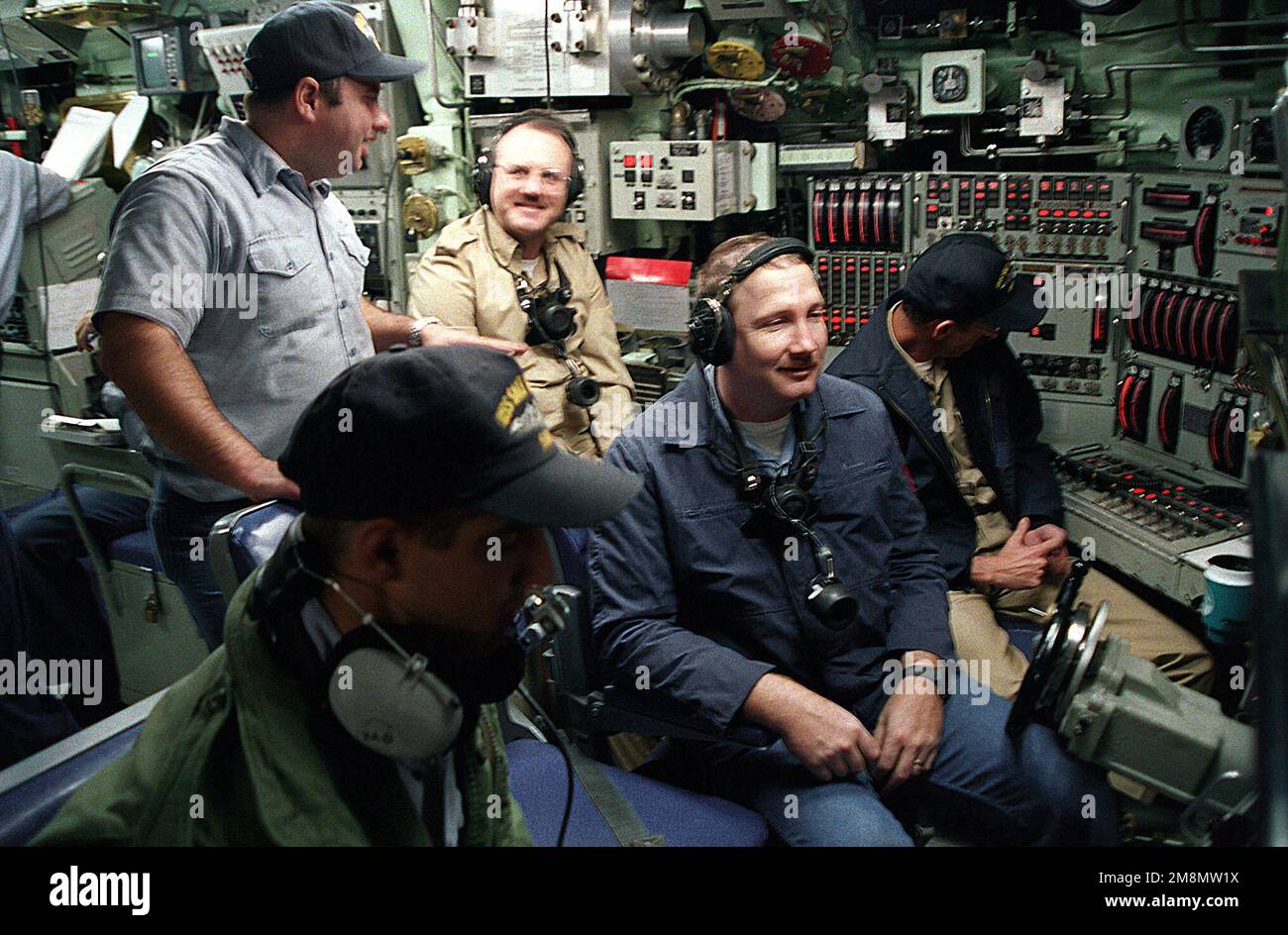 Crewmen aboard the Los Angeles class submarine USS SALT LAKE CITY (SSN ...