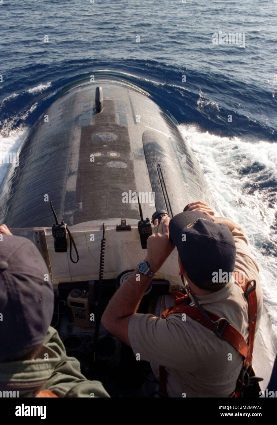 Lookouts aboard the submarine USS SALT LAKE CITY (SSN-716) watch for ...