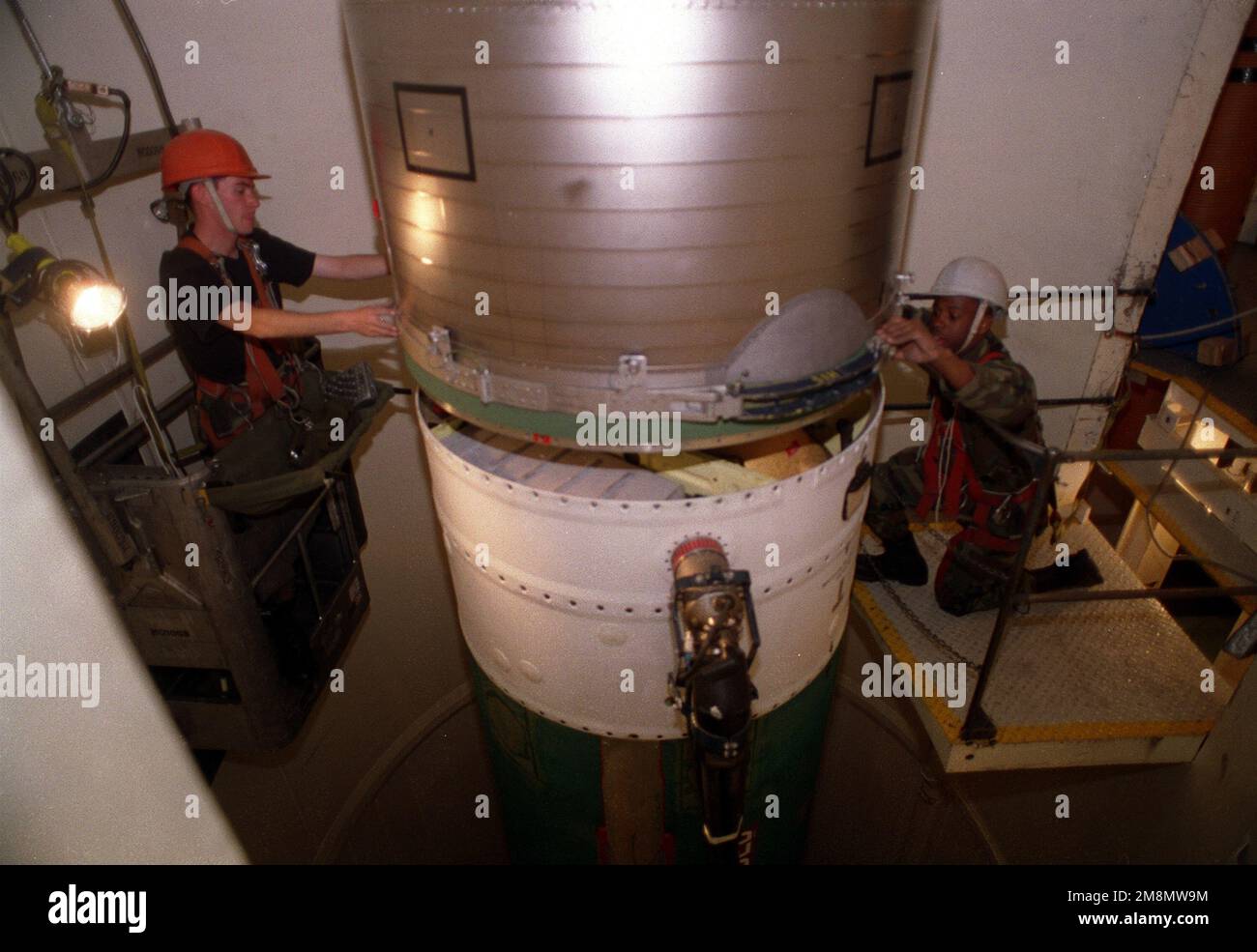 Air Force maintenance technicians from 90th Space Wing conduct a ...
