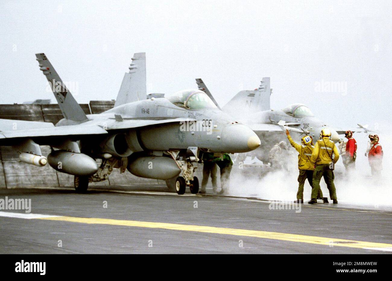 Crew members from Air Department aboard USS NIMITZ (CVN 68), make final ...