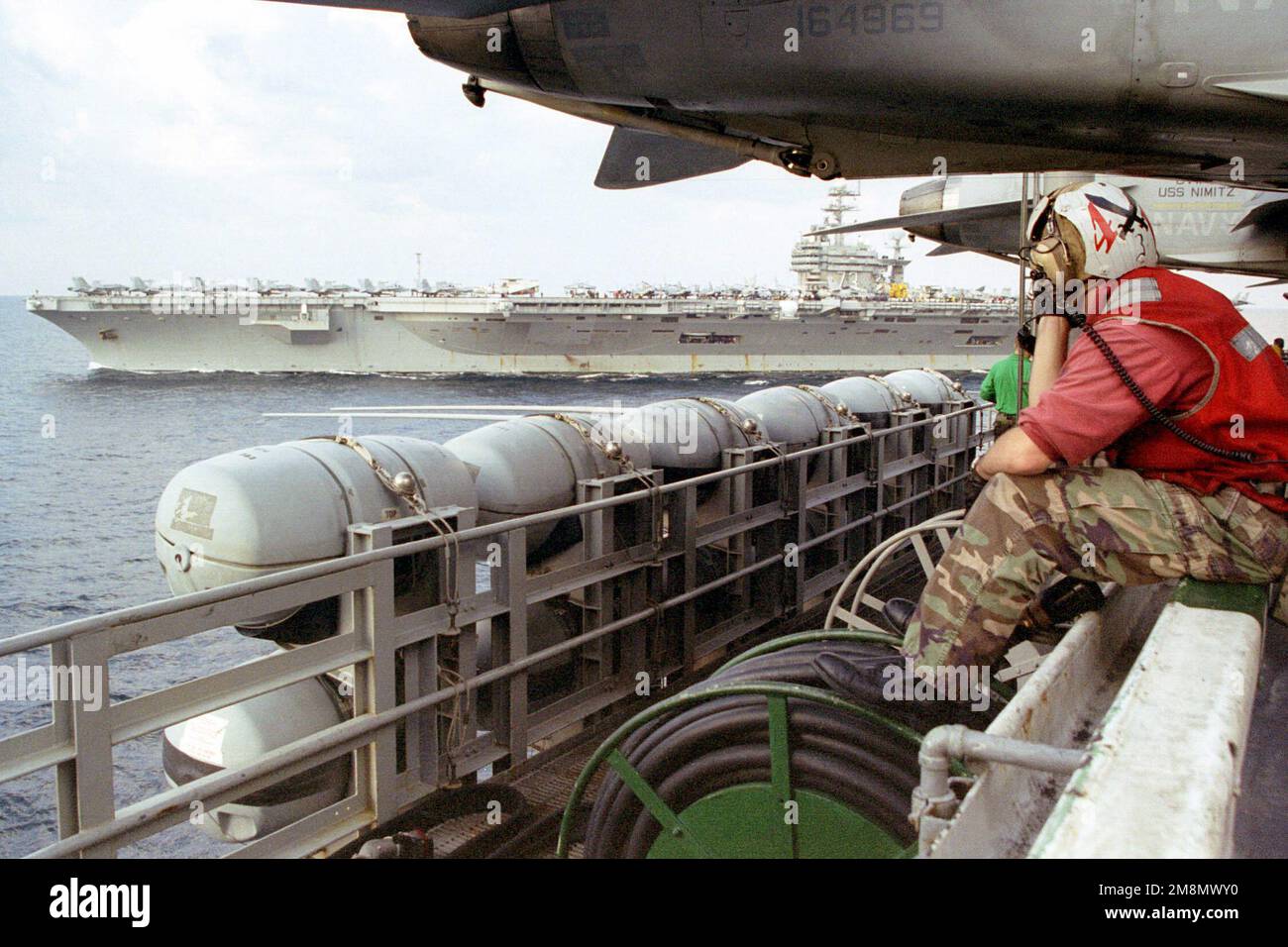 A US Navy sailor on board the nuclear powered aircraft carrier USS ...