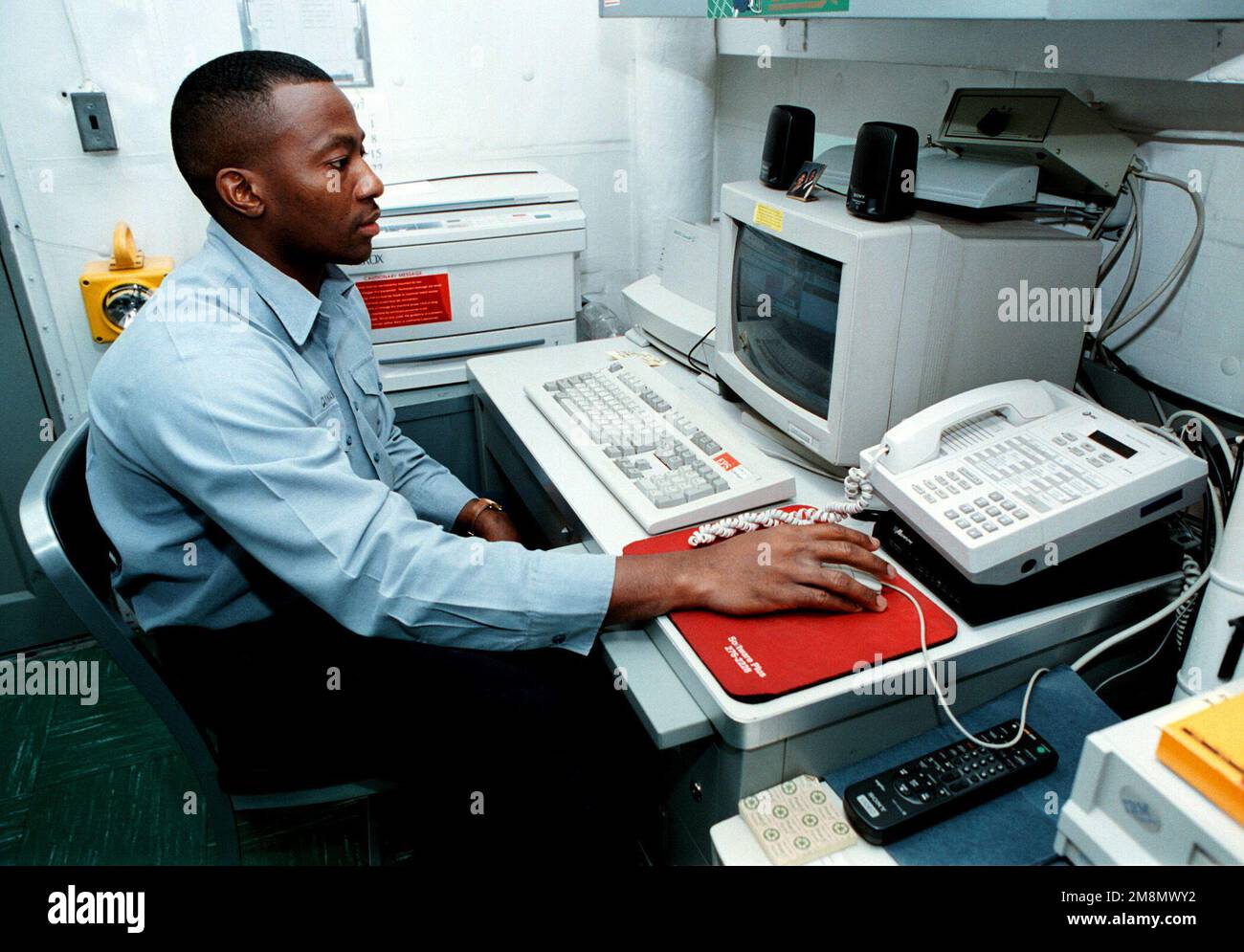 Yeoman 2nd Class William Cunningham performs administrative duties for ...