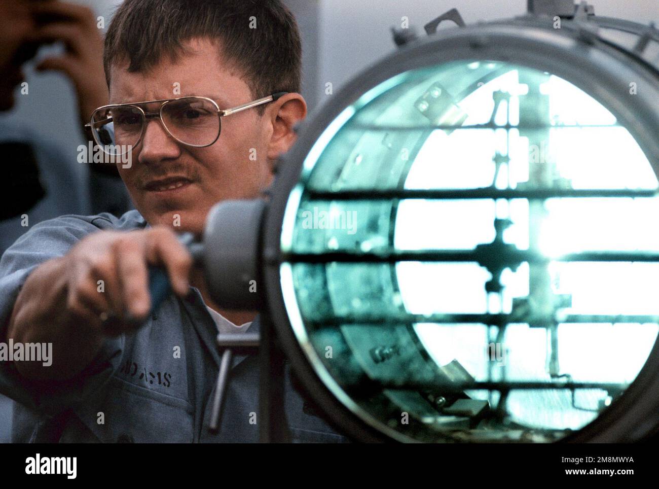 Signalman 3rd Class Calvin Adams flashes Morse code from the signal ...