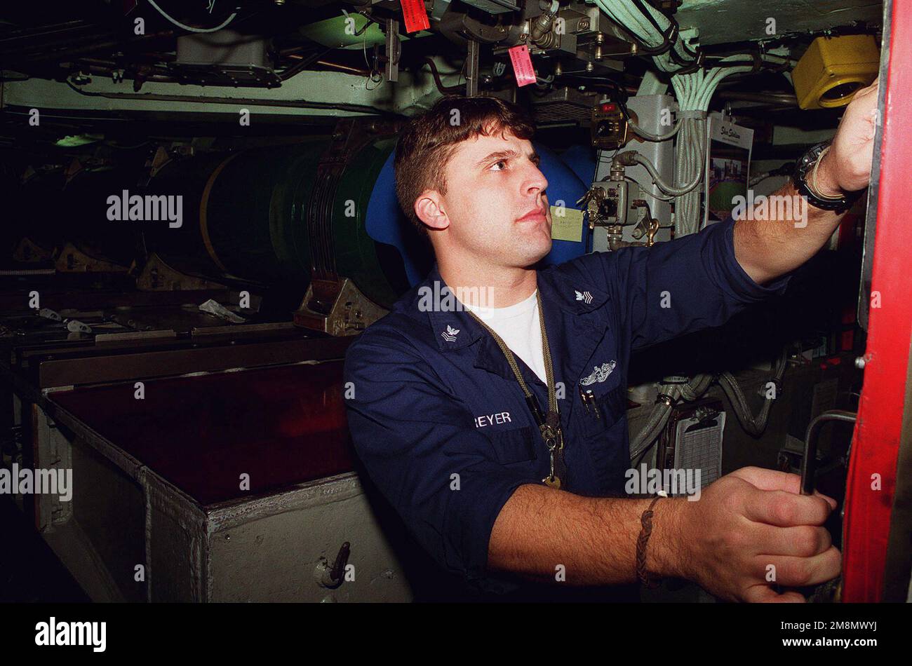 Torpedoman 1ST (TM1) Class Scott Freyer checks a weapons fire control ...