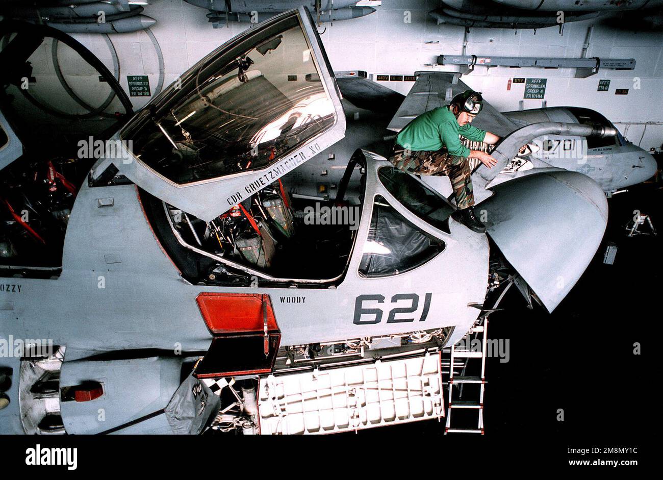 Aviation Machinists Mate 1ST Class Michael Walcott performs maintenance ...