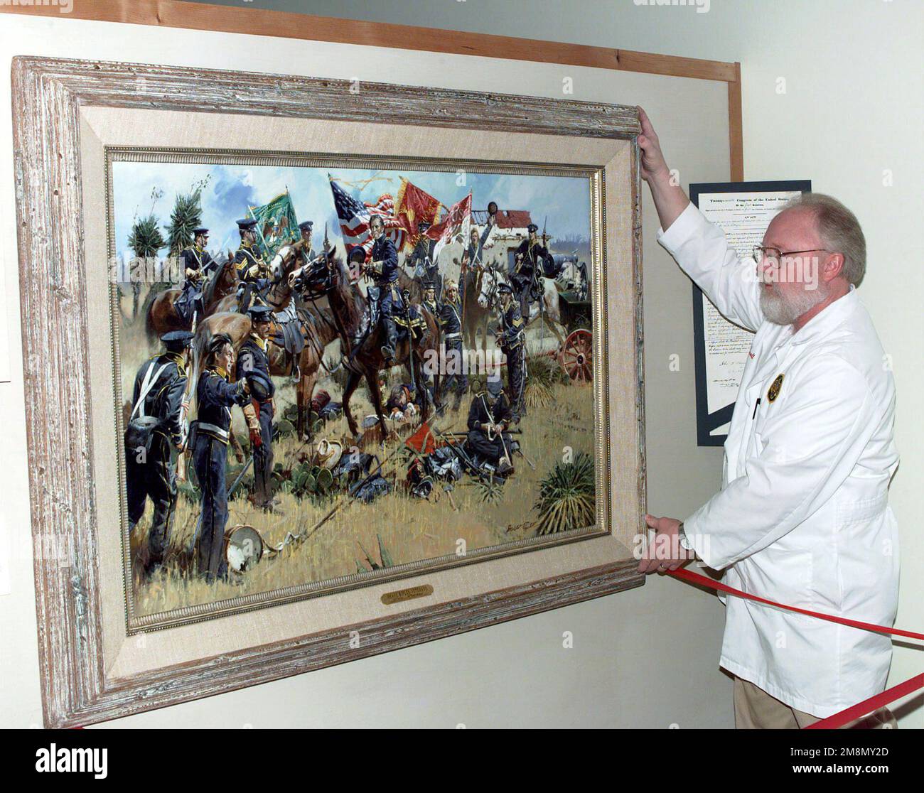 Scott Hamric, Registrar at the 3rd Cavalry Museum, is shown adjusting ...