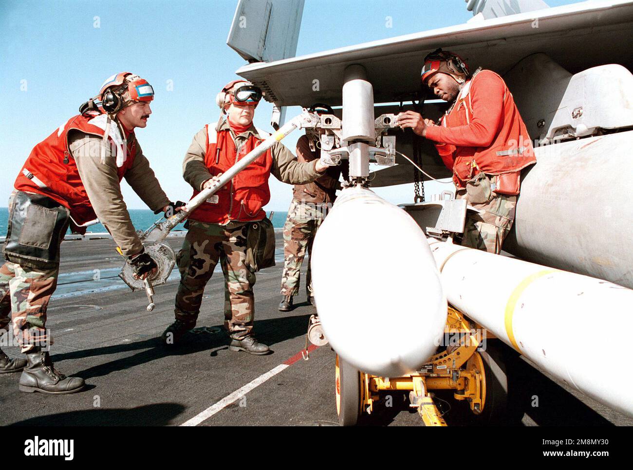 US Navy Aviation Ordnancemen (AO) Edward Green, (left) AO David Butts ...