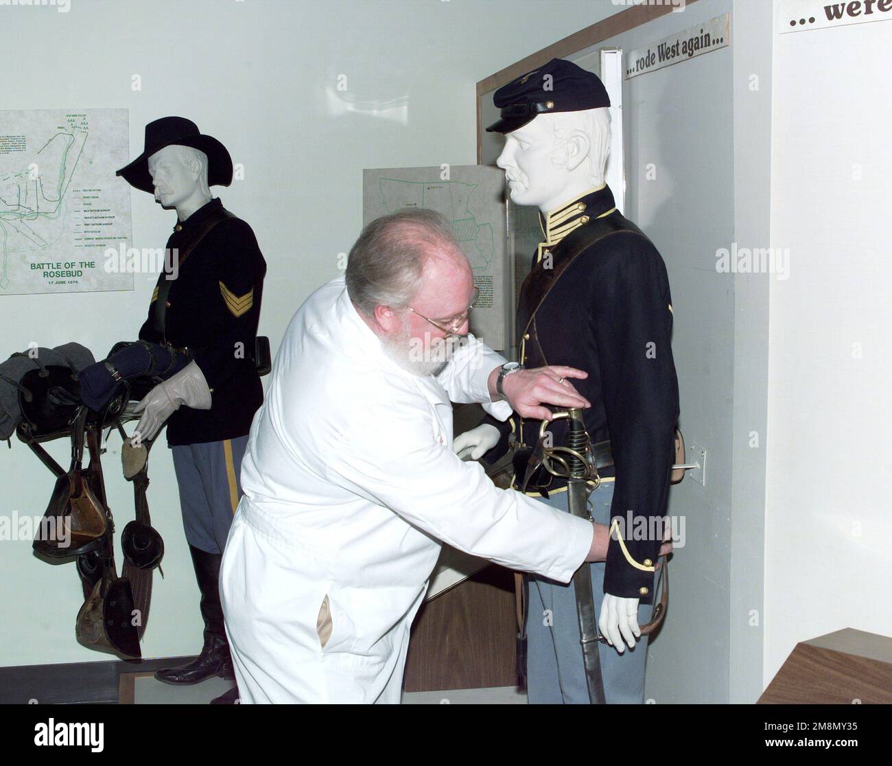 Scott Hamric, Registrar at the 3rd Cavalry Museum, works on a display ...