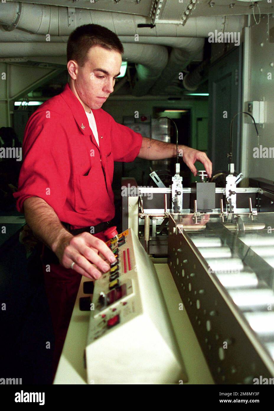 US Navy Lithographer 3rd Class (LI3) Scott Libby makes final settings ...
