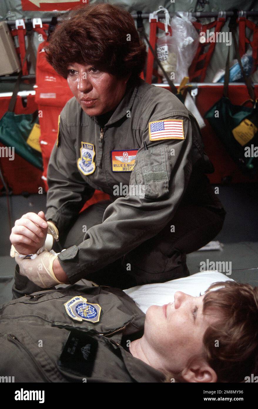 MASTER Sergeant Millie Mahoney checks the pulse of patient, Major Lyhal ...