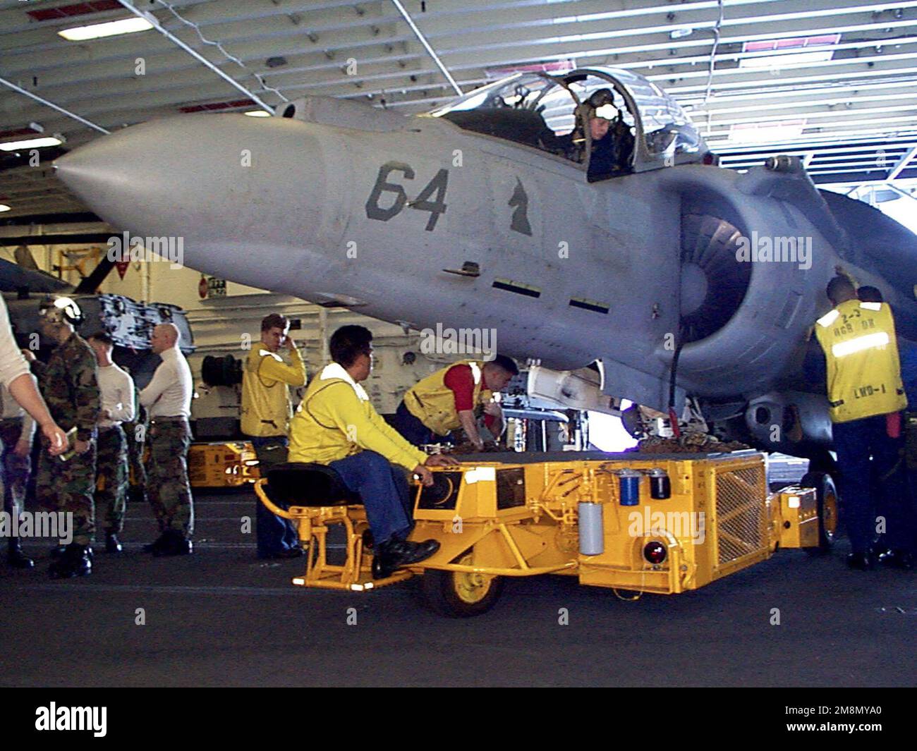 Crew members aboard the amphibious assault ship USS WASP (LHD 1) move ...