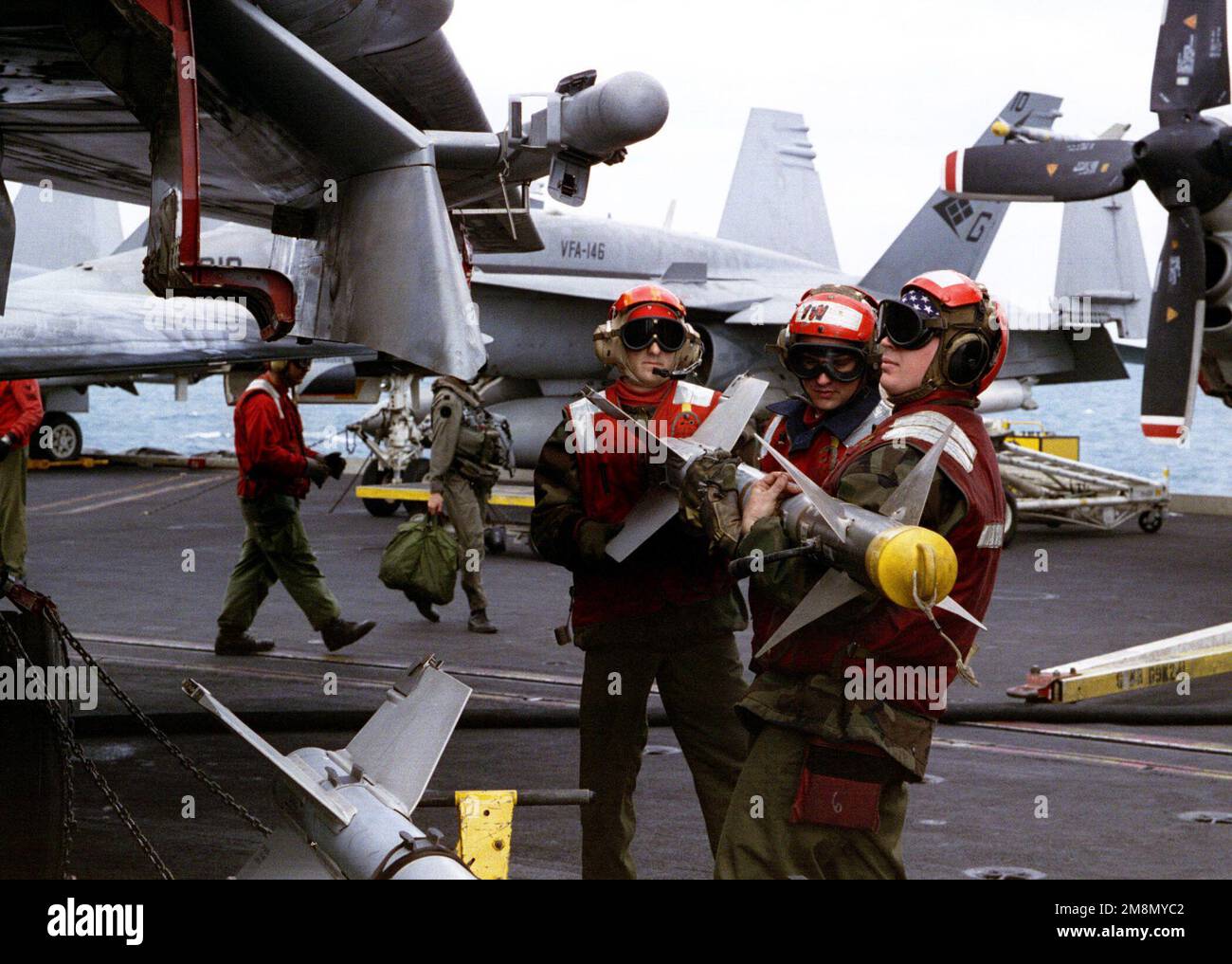 Crew members attached to Fighter Squadron Two One One (VF-211) mount an ...