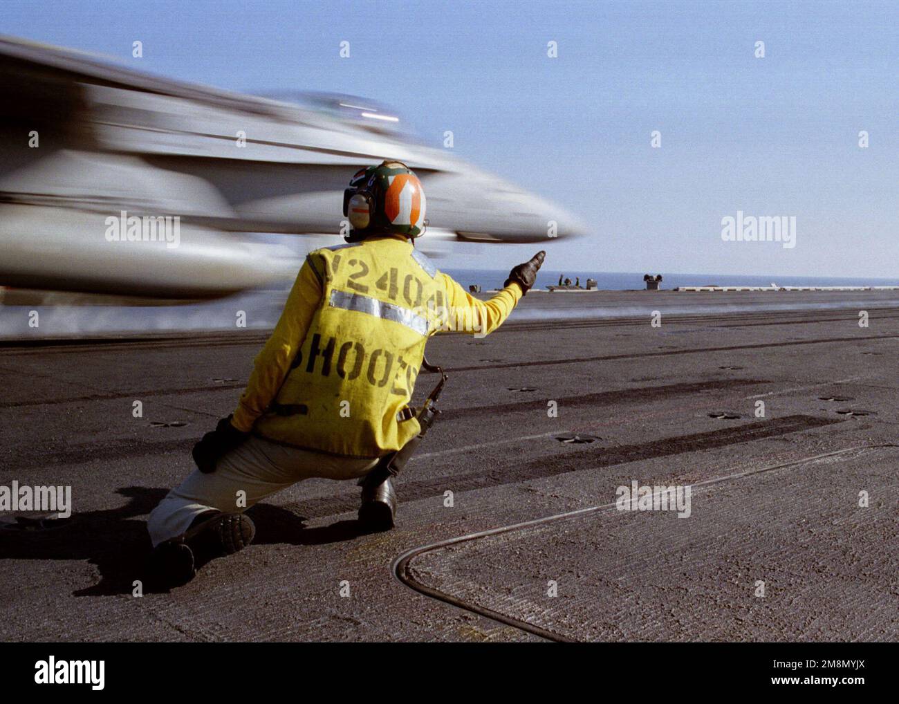 LT Carl E. Crabtree signals an F/A-18C Hornet clear for launch off the ...