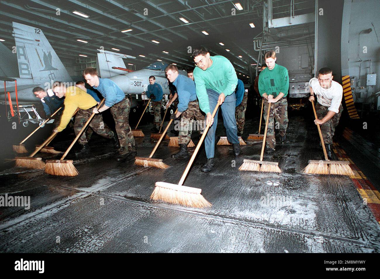 US Navy Crewmen aboard the nuclear powered aircraft carrier USS GEORGE ...