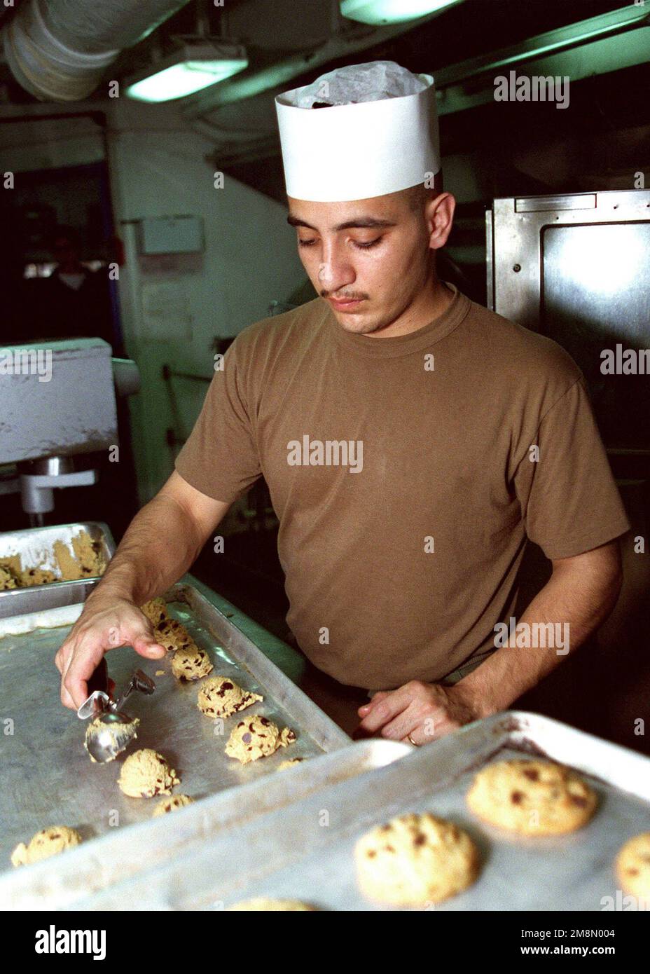 U.S. Marine Corps CPL. Victor Medrano prepares chocolate chip cookies ...
