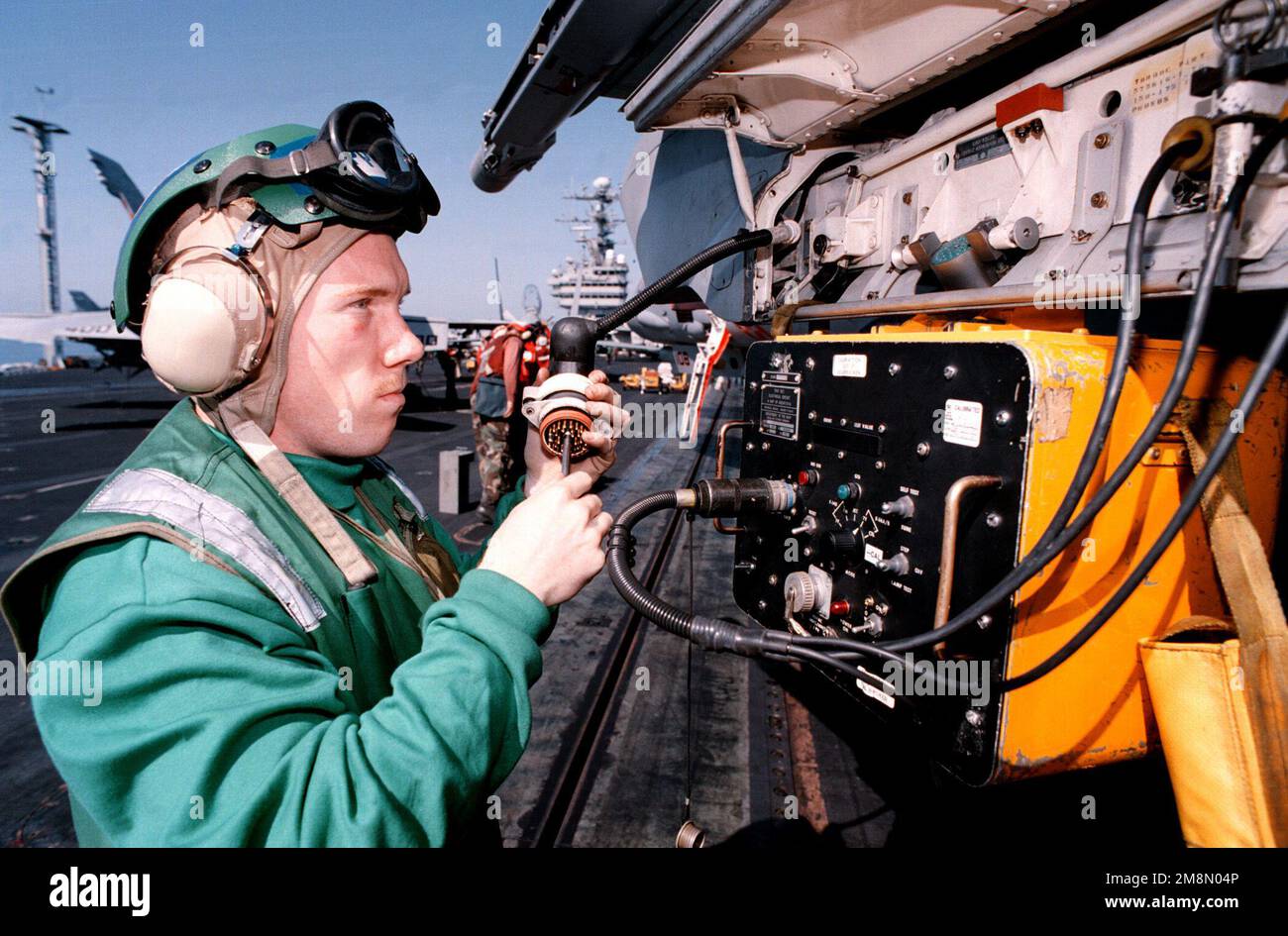 Aviation Electronics Technician AIRMAN Apprentice Patrick McKinley performs a maintenance check ...