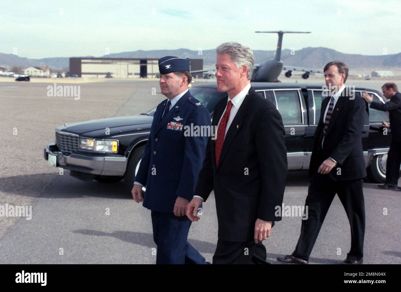 Air Force COL Gary Dills, commander of the 377th Air Base Wing, escorts ...