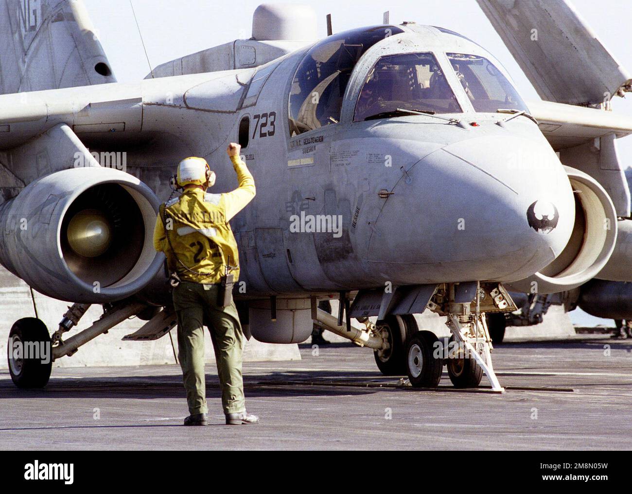 Aviation Boatswains Mate 3rd Class John Brady communicates with an S-3 ...