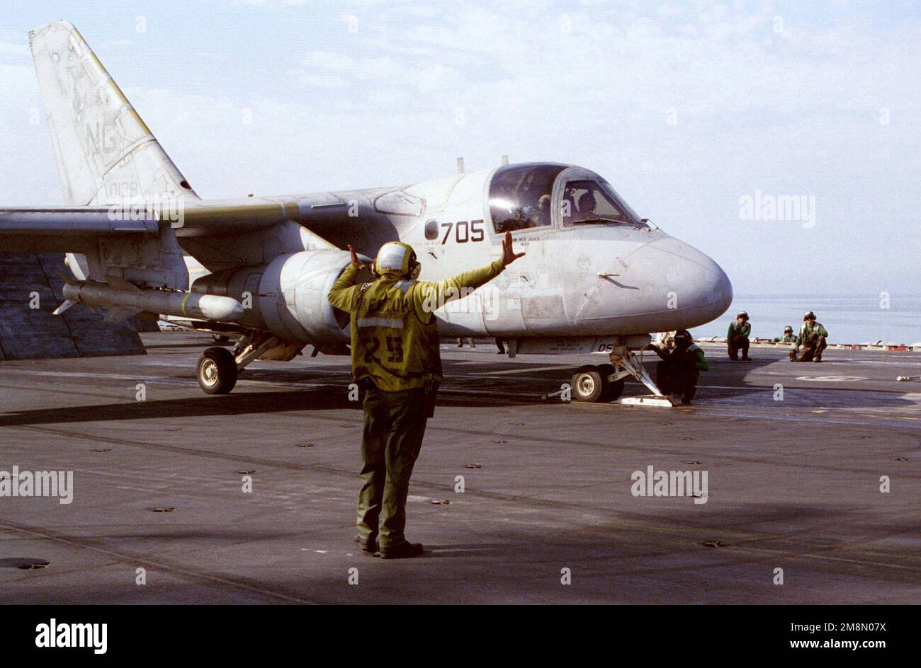 Aviation Boatswains Mate (Handler) John Brady signals the pilot of an S ...
