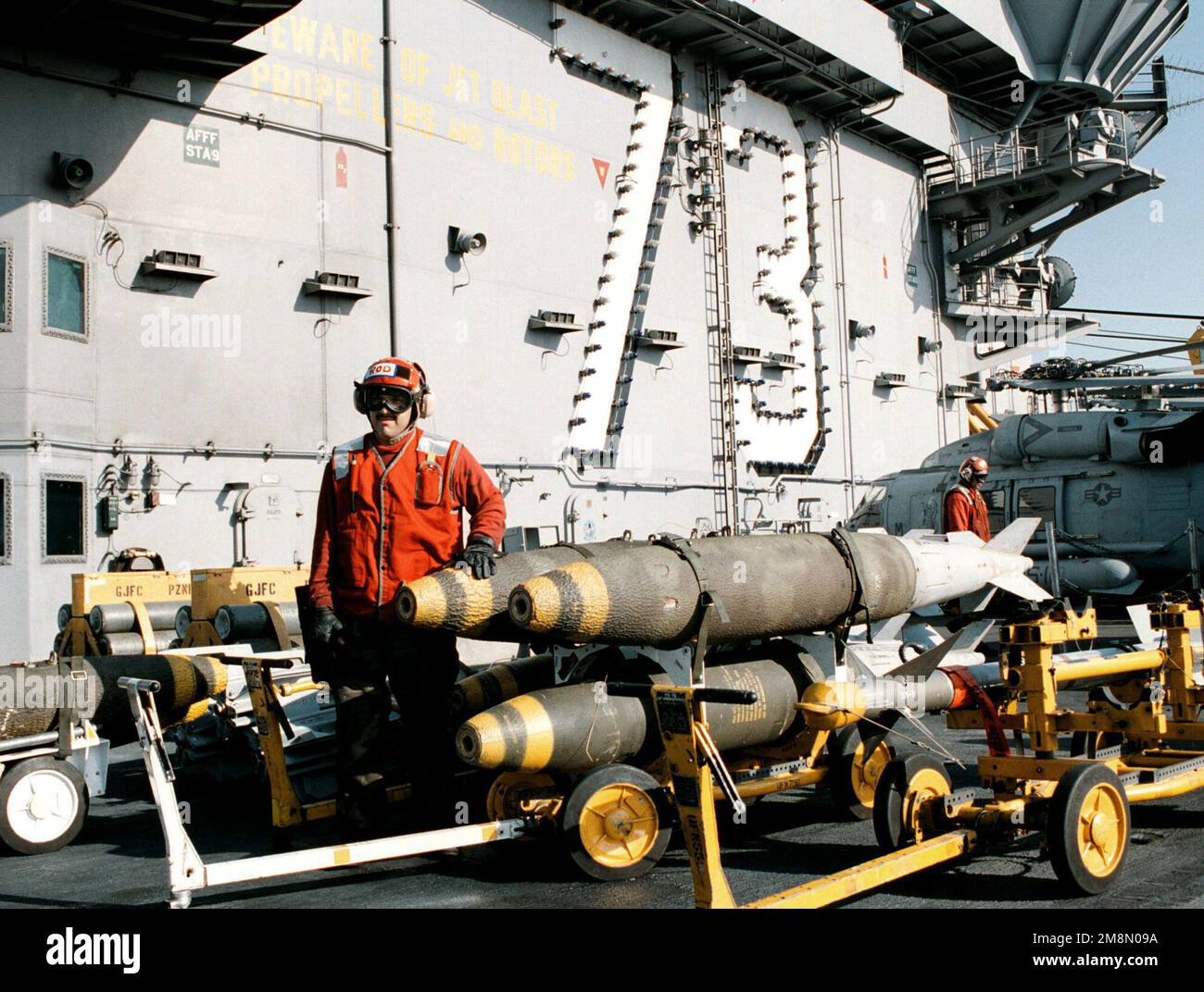 Aviation Ordnanceman Third Class Hans Rodriguez stands ready to load MK ...