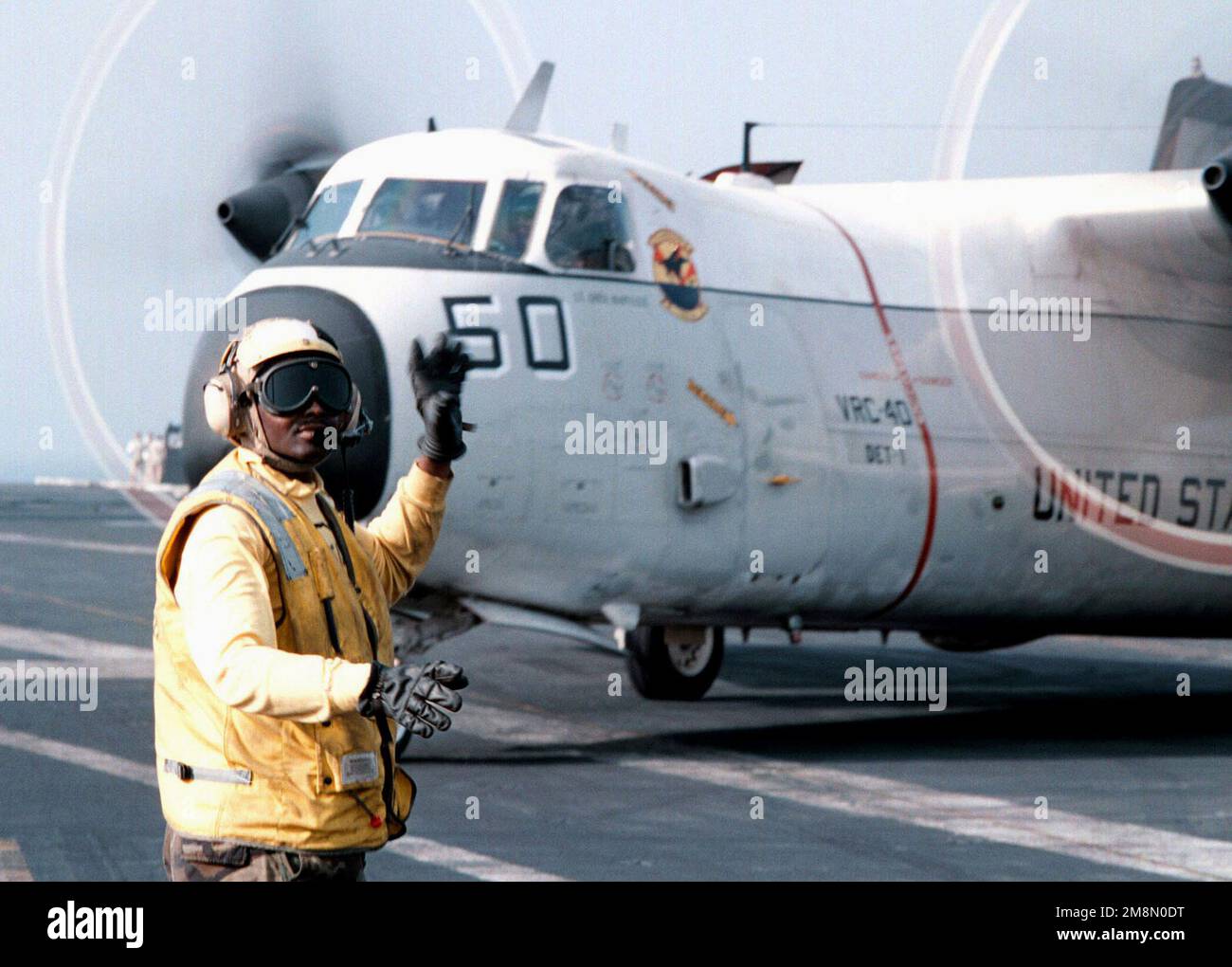 AMN Marcus Charles directs a C-2 Greyhound from across the flight deck ...