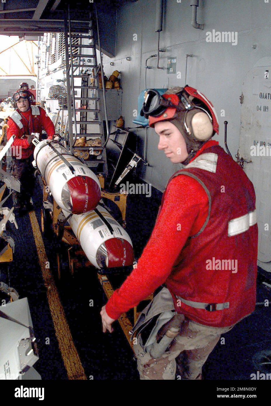 US Navy Aviation Ordnanceman AIRMAN (AOAN) David Rodriguez (front ...