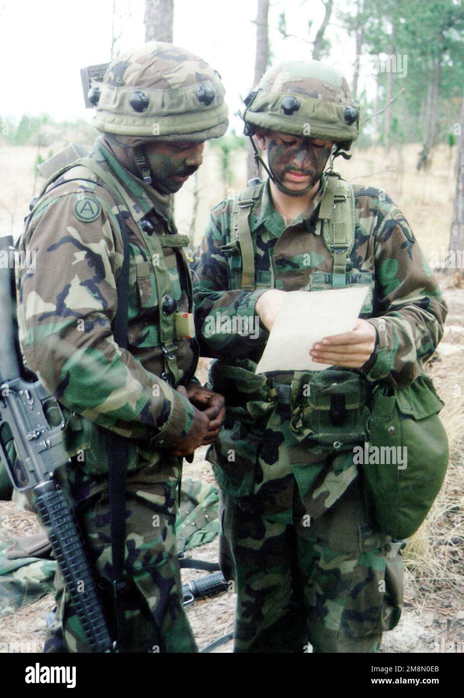 SPC Marwan Nushwat (right) and SPC Mark Martin look over regulations ...