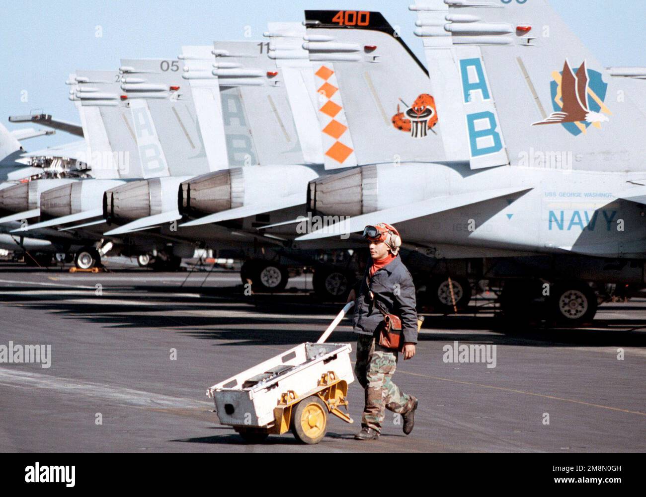 Aviation Ordnanceman 3rd Class Salvador Garcia, pushes a cart of ...