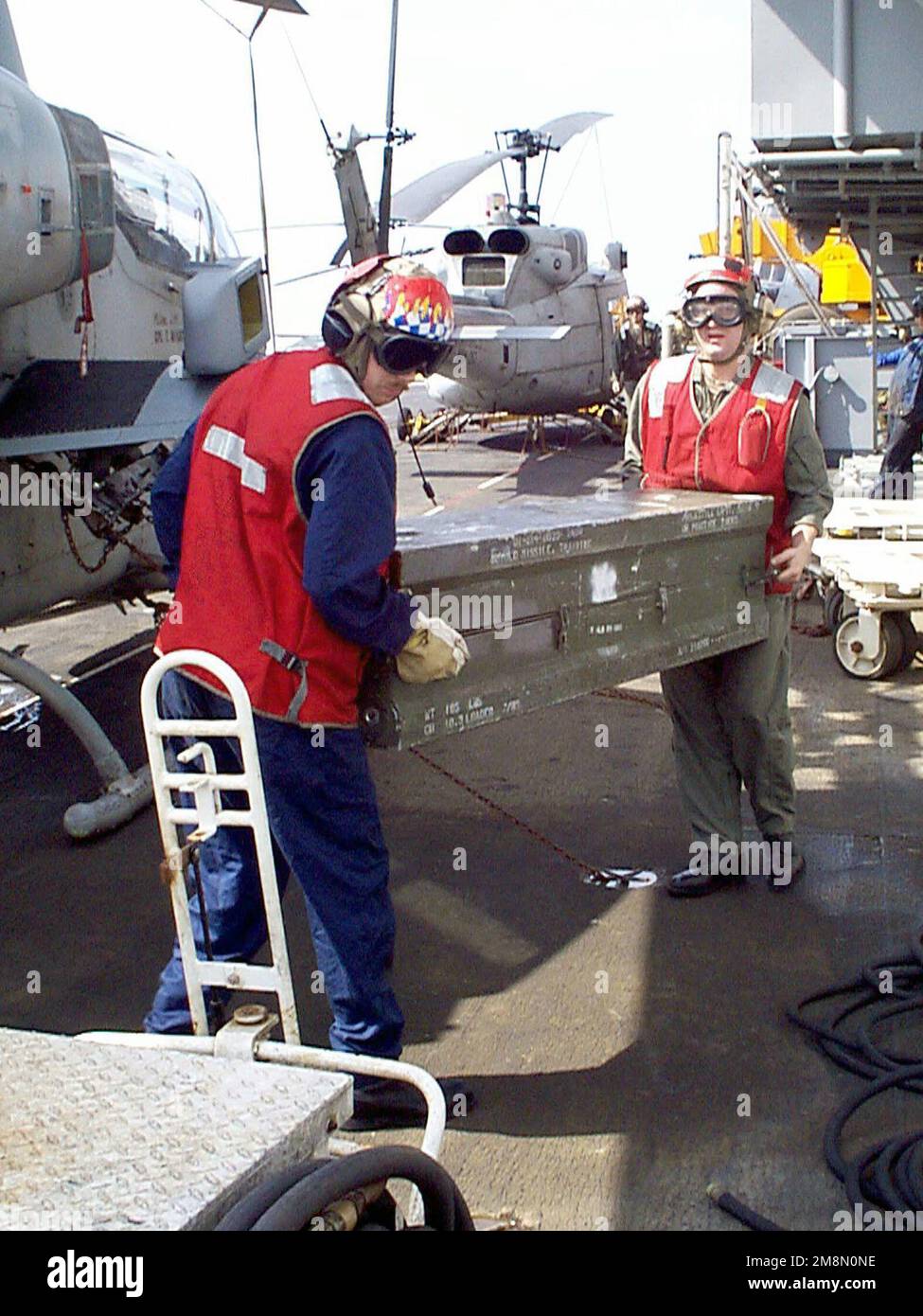 United States Navy, Aviation Ordnancemen move weapons, in a shipping ...