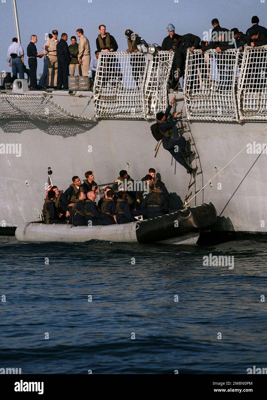 Crew members return to the USS CARNEY (DDG 64) after standing a 12 hour ...