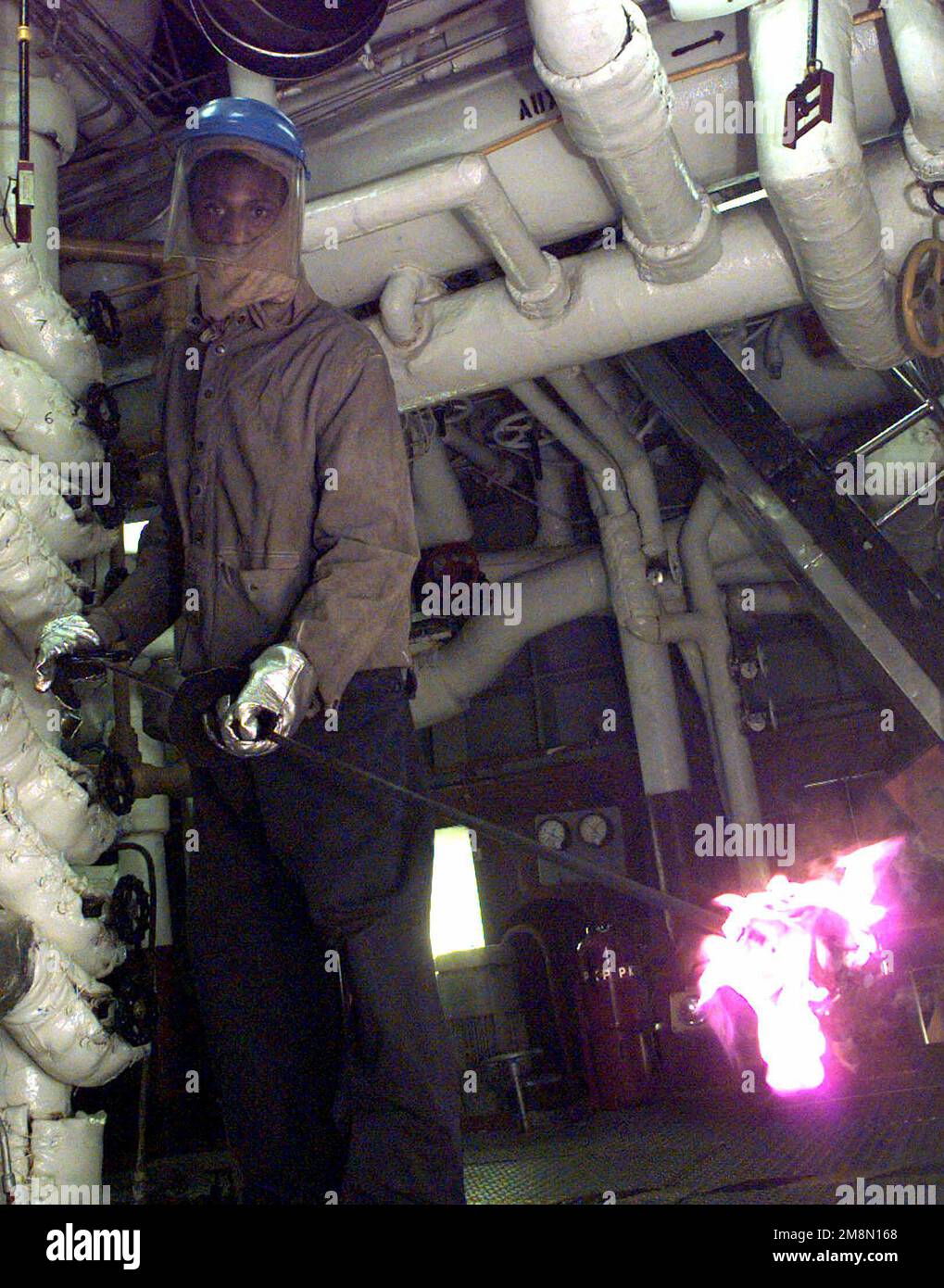 US Navy Machinist's Mate Third Class Dwan Barsh prepares to light an ...