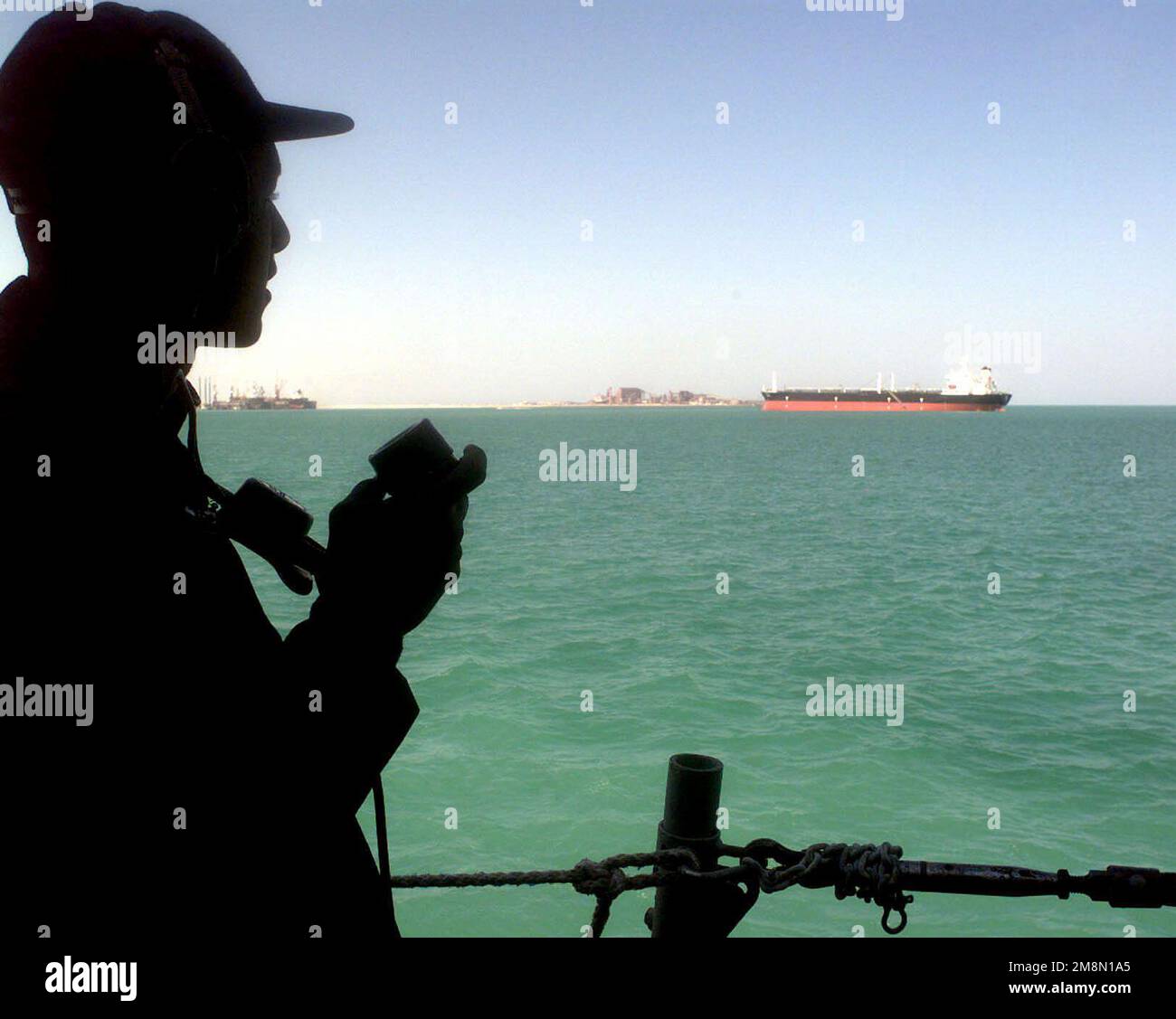 US Navy Storekeeper SEAMAN Joel Paula stands lookout aboard the Oliver ...