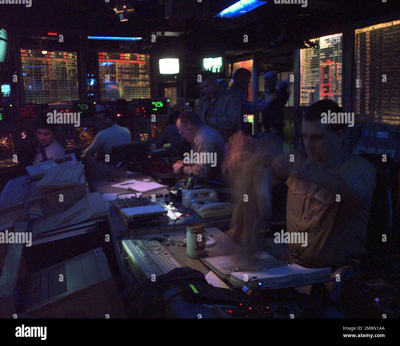 US Navy Lieutenant Bill Lucas (Foreground) dons a protective cover ...