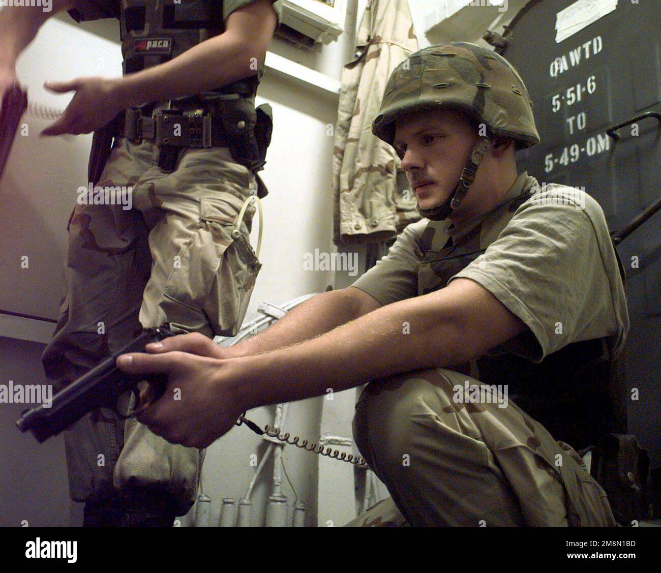 Two US Marines draw their 9mm pistols to cover a hatch opening (Not ...