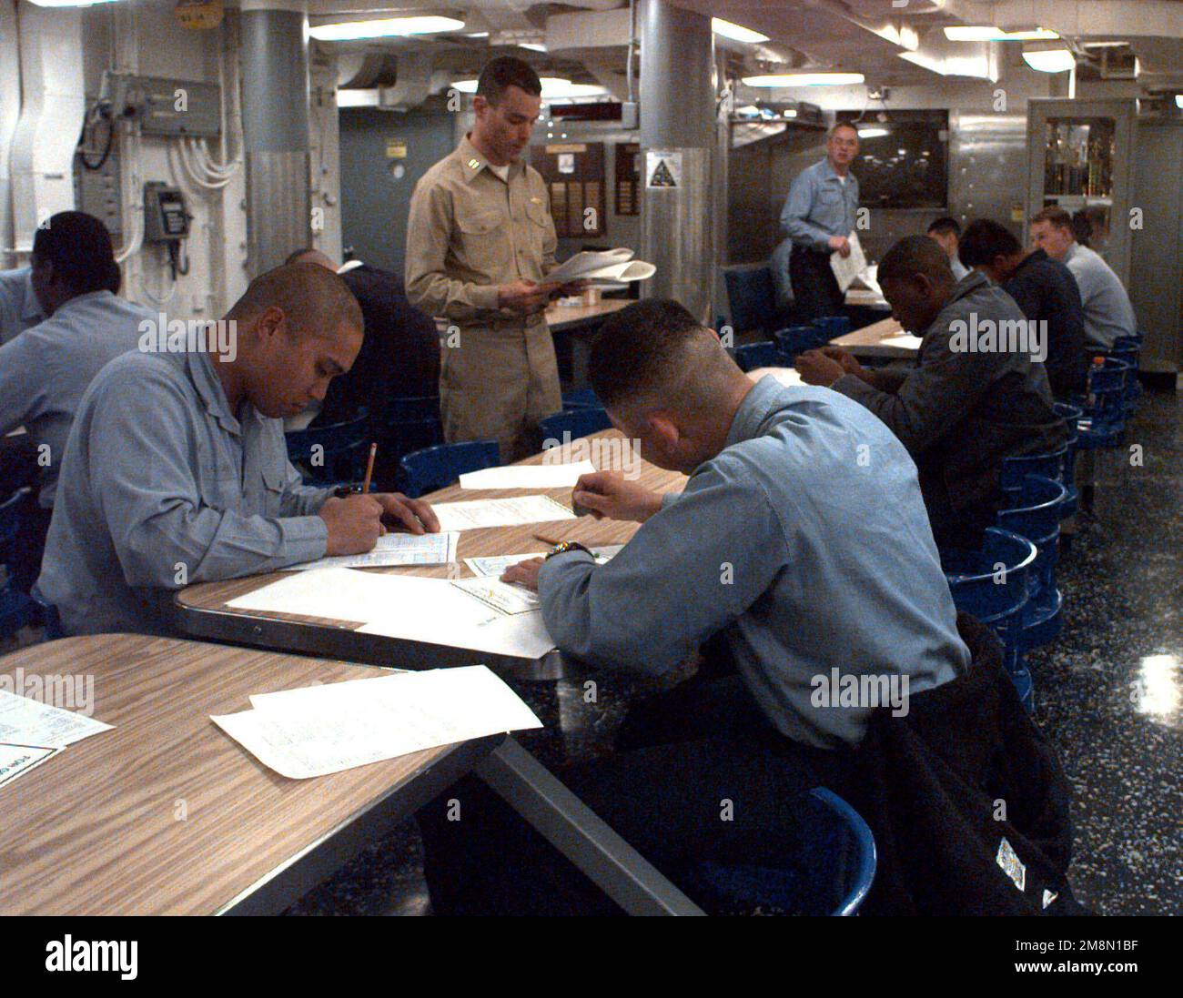 US Navy Lieutenant Steven H. DeMoss (Standing foreground), ship's ...