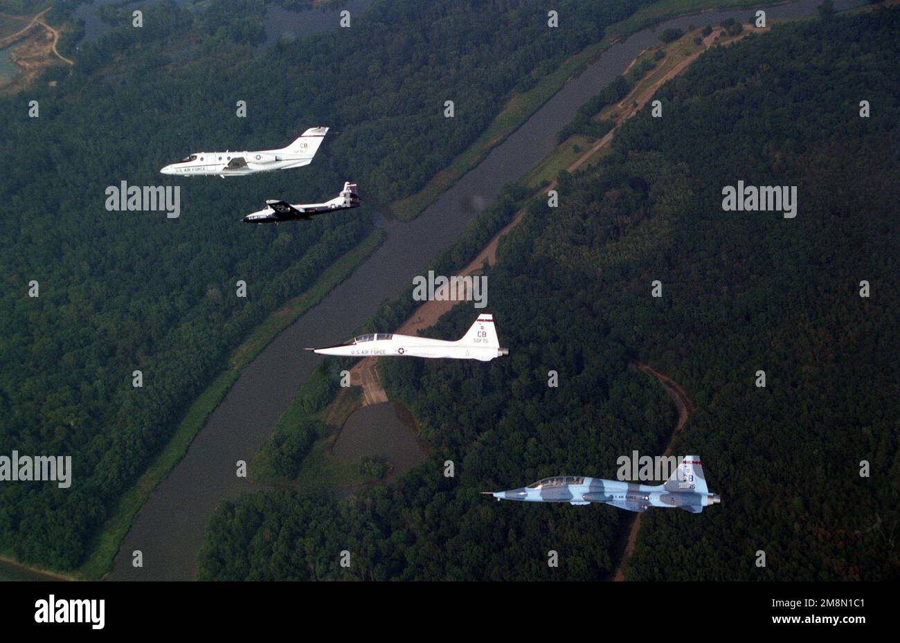 A USAF T-38 Talon aircraft, with a camouflaged paint scheme, along with ...