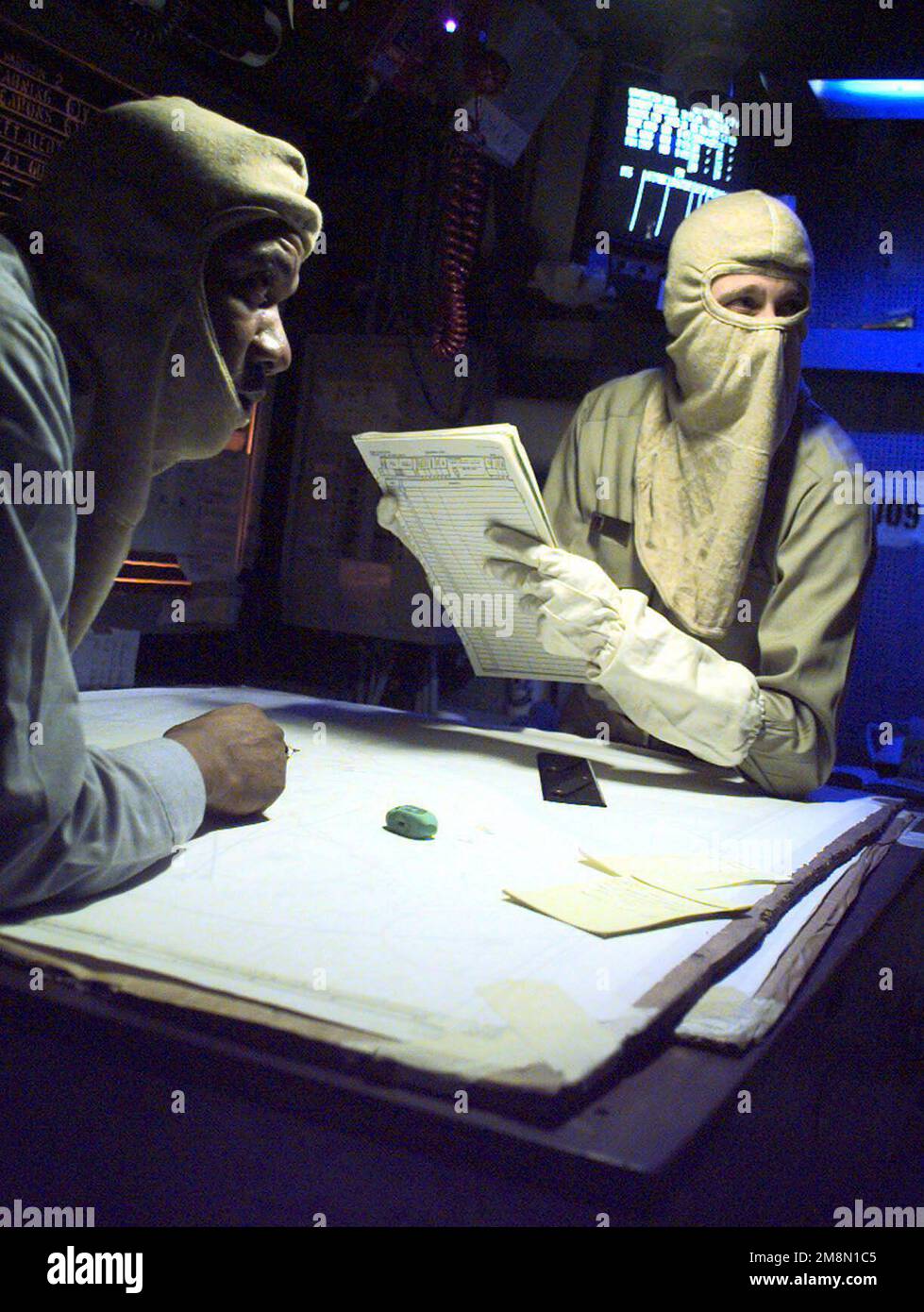 Two US Navy Sailors review charts and plot on a map in the Forrestal ...