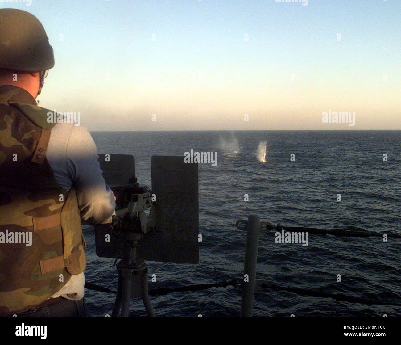 US Navy Fire Control Technician 3rd Class Mendleson fires a M-2 .50 ...