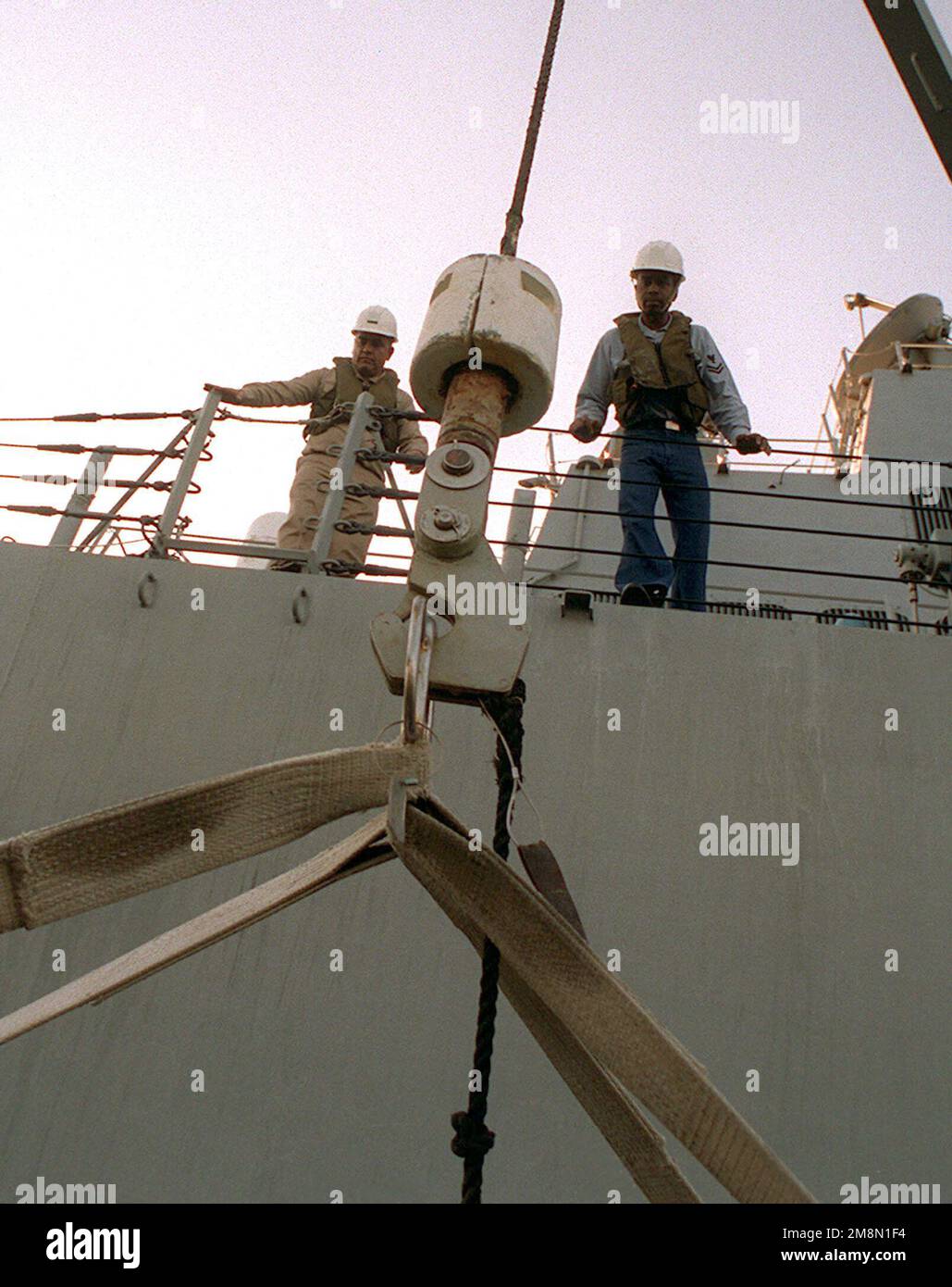 The cable, hook and strap assembly are seen as CHIEF PETTY Officer ...