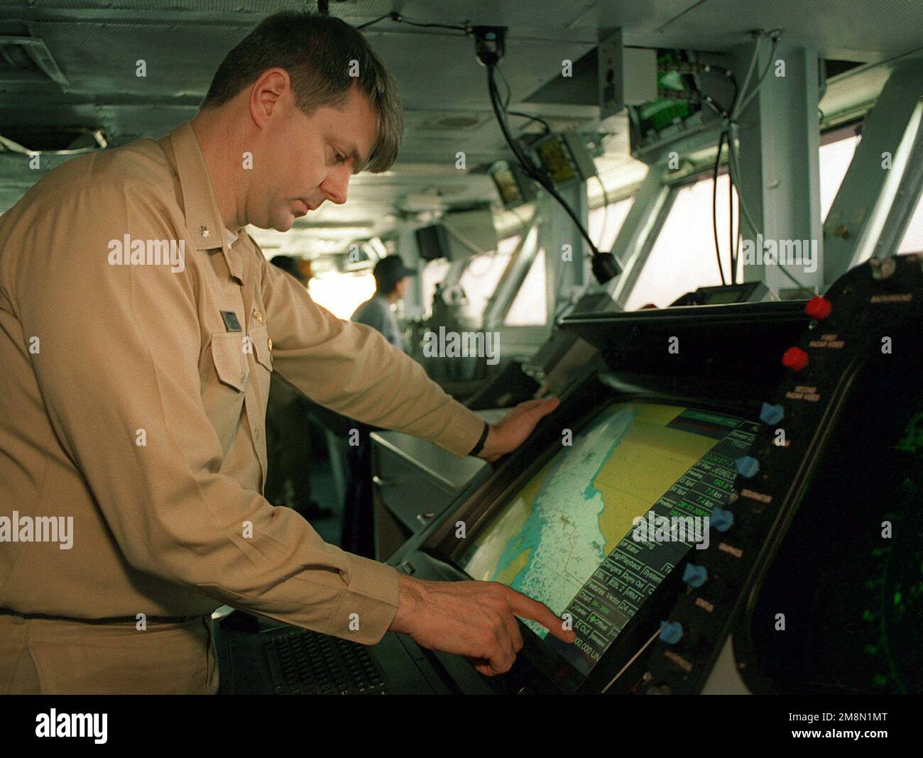 CDR Ron Raymer, navigator of USS GEORGE WASHINGTON (CVN-73), works on ...