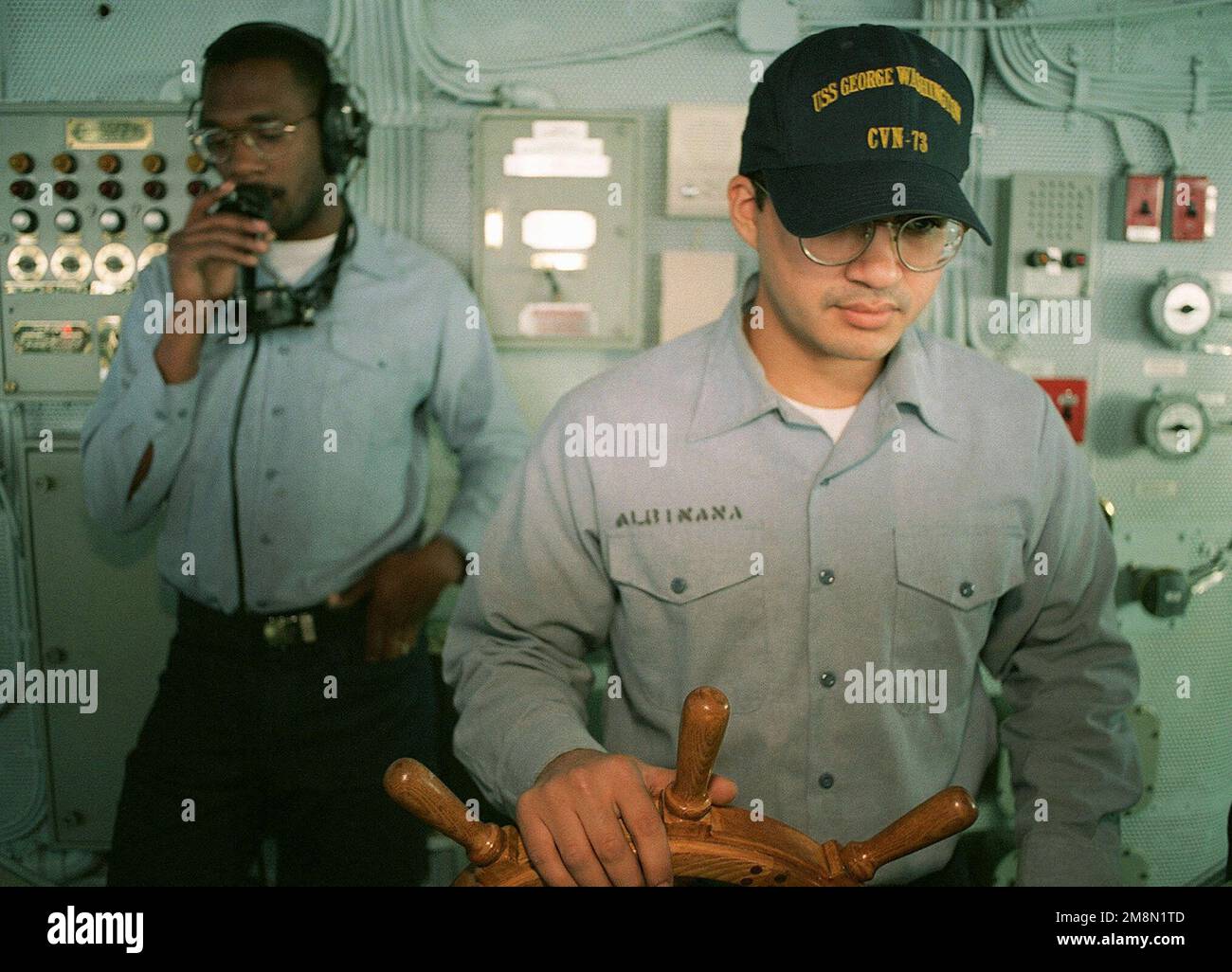 SEAMAN James Albinana mans the steering wheel of the aircraft carrier ...