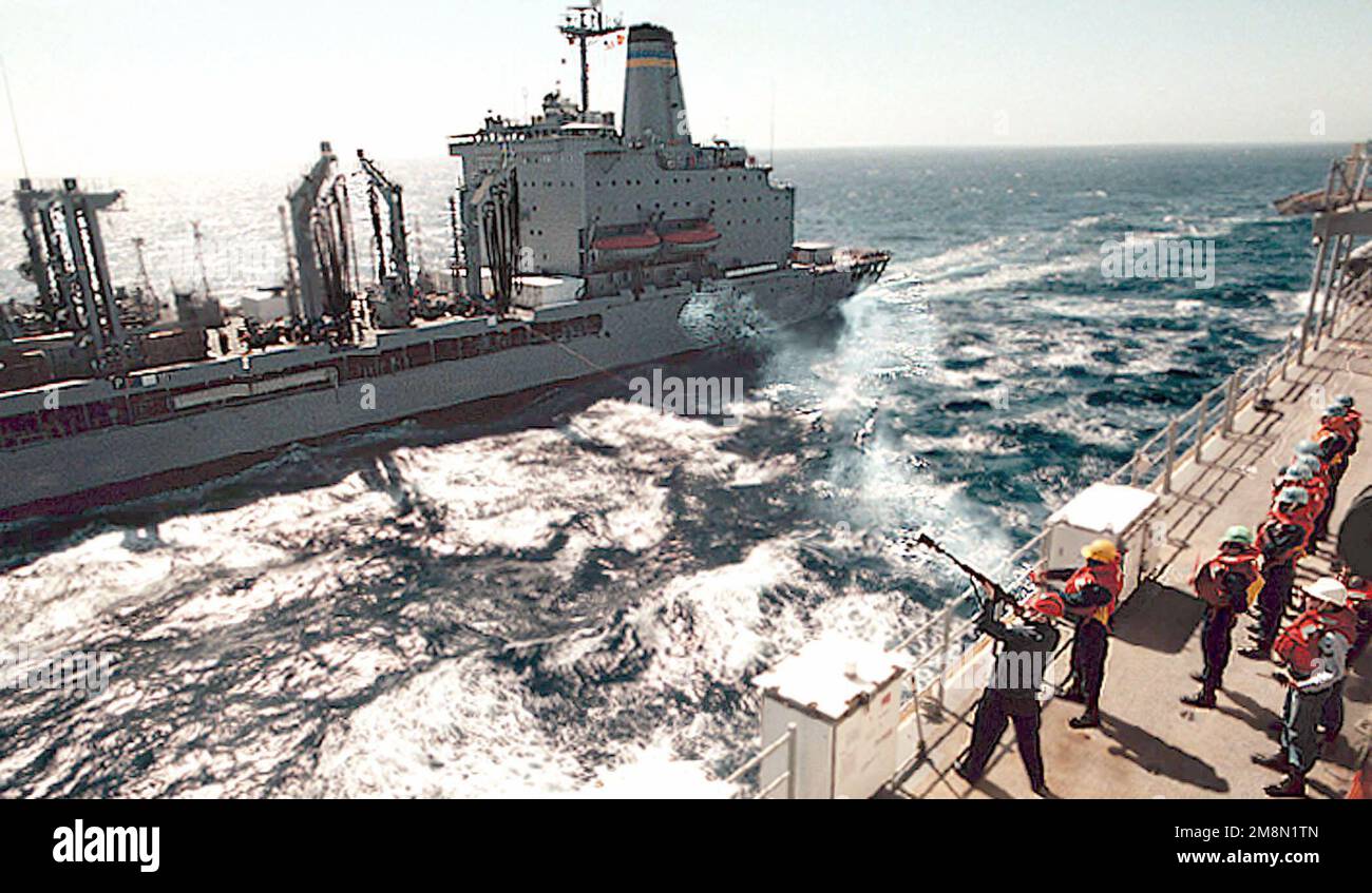US Navy GUNNER's Mate 3rd Class James L. Wolfe fires a shotline from ...