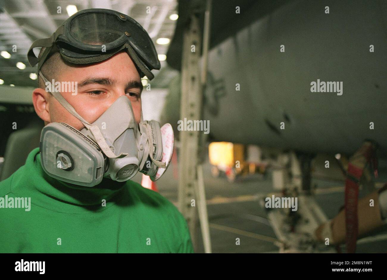 LCPL Chris Benavides dons a face mask while spraying primer (not shown ...
