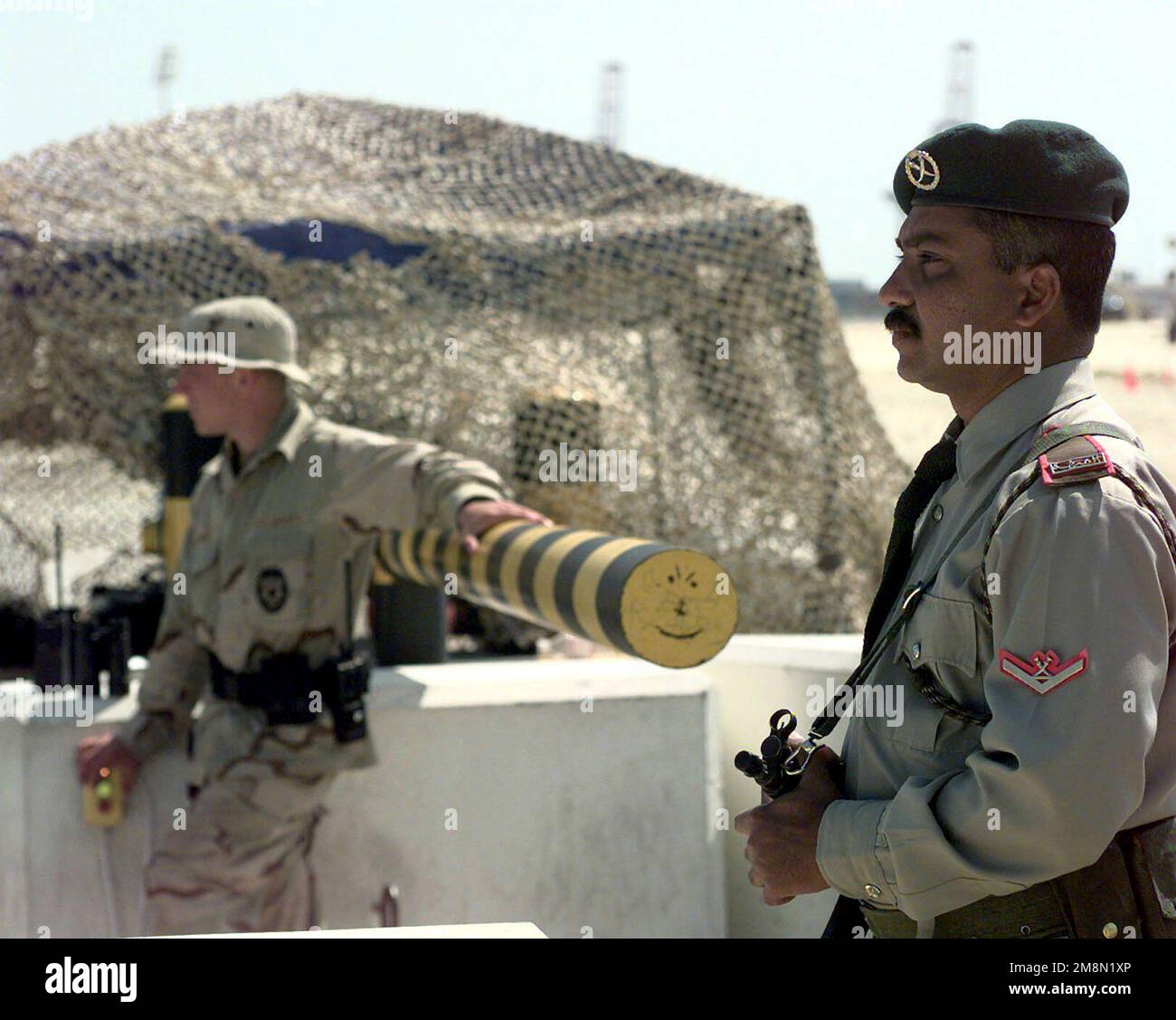 An officer from the Bahrainian Police Force (Right) and US Navy SEAMAN ...