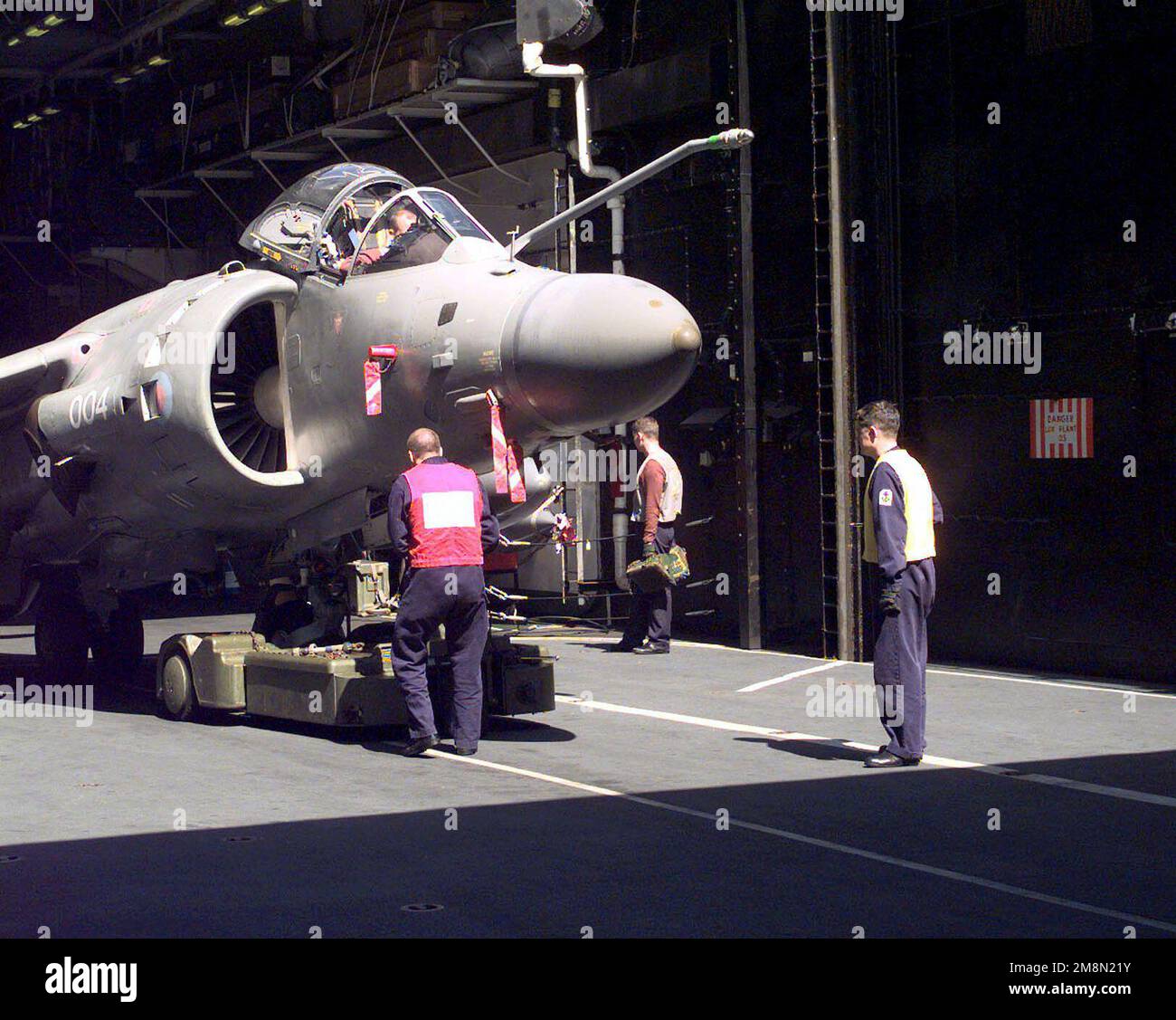 British Crewmen move a Royal Navy FA-2 Sea Harrier onto the flight deck ...